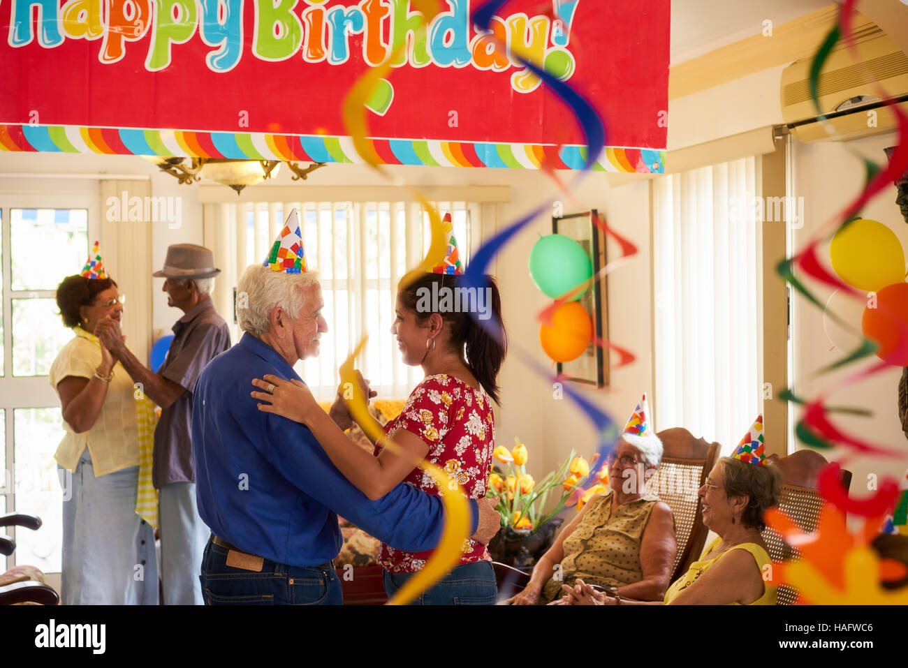 Group of old friends and family celebrating senior man birthday in ...