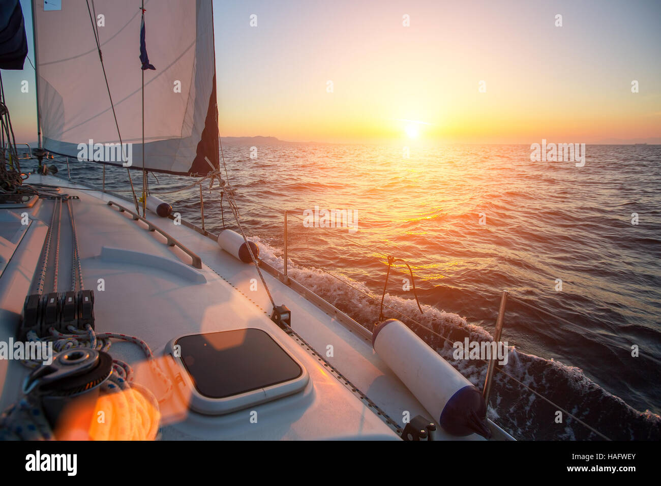 Sailing ship yachts in the open Sea during fantastic sunset. Luxury ...