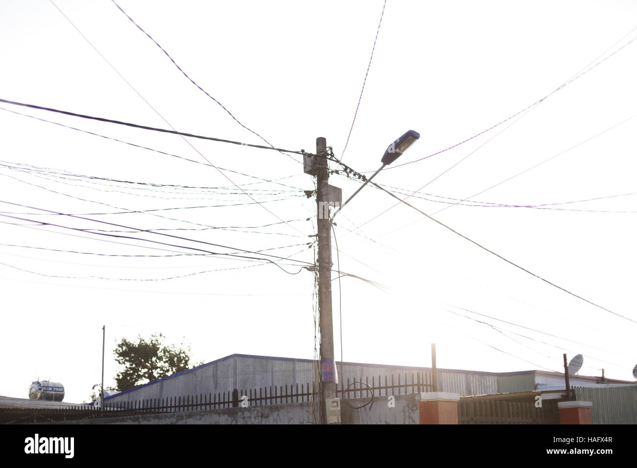 Backlit electricity power lines and pylon Stock Photo - Alamy