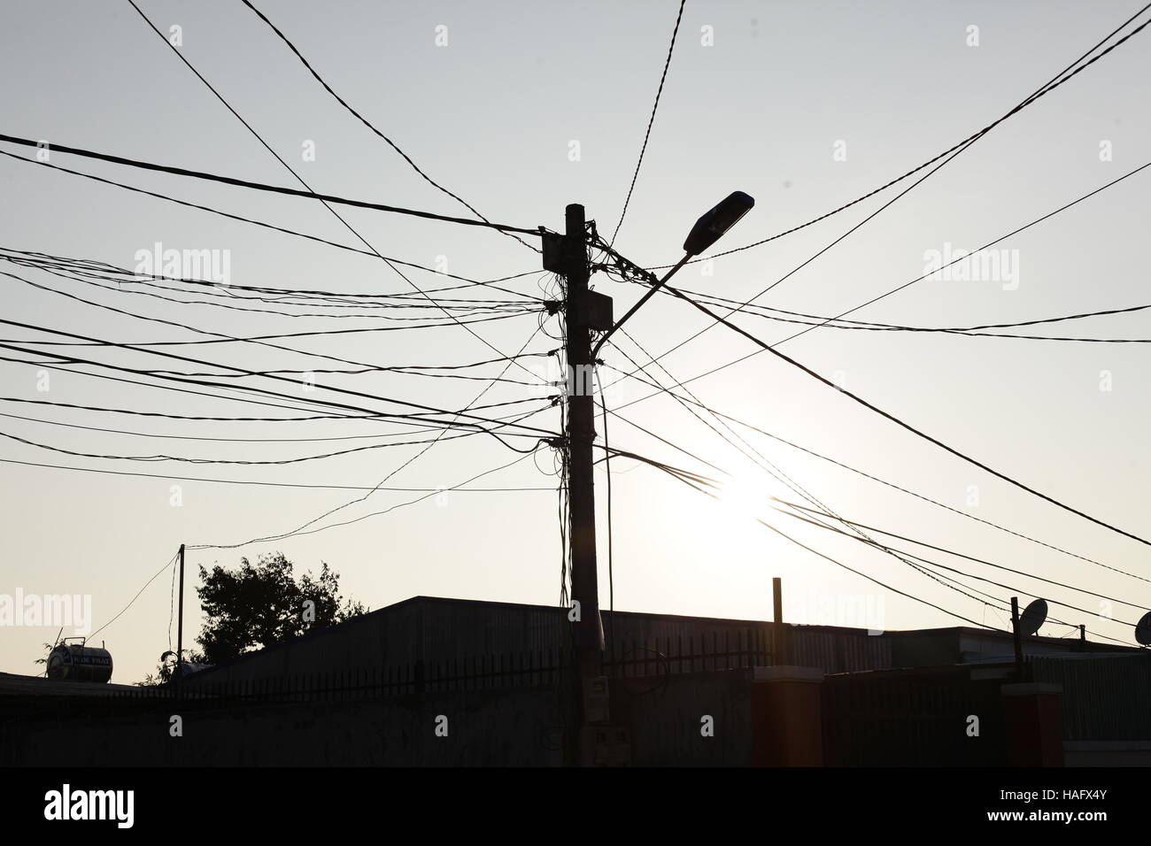 Backlit electricity power lines and pylon Stock Photo - Alamy