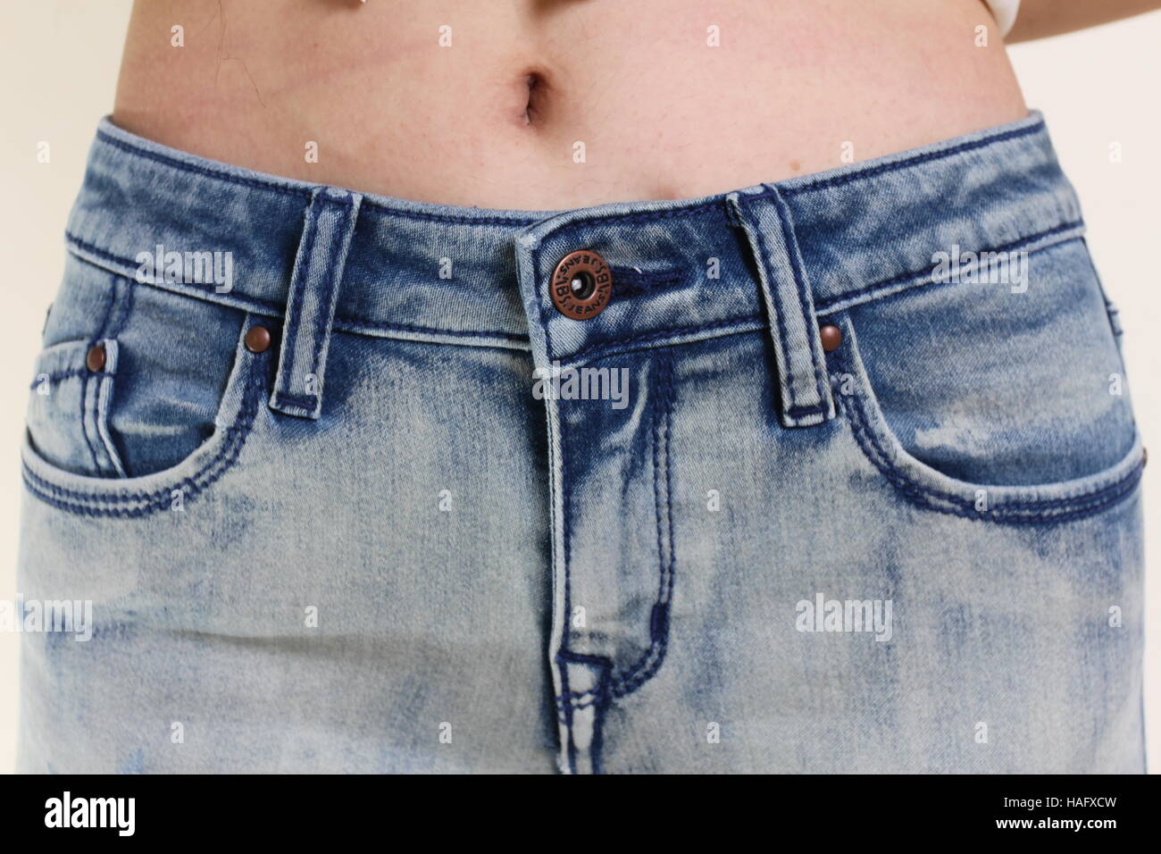 Woman in jeans. Close-up side view of in isolated on white Stock Photo ...