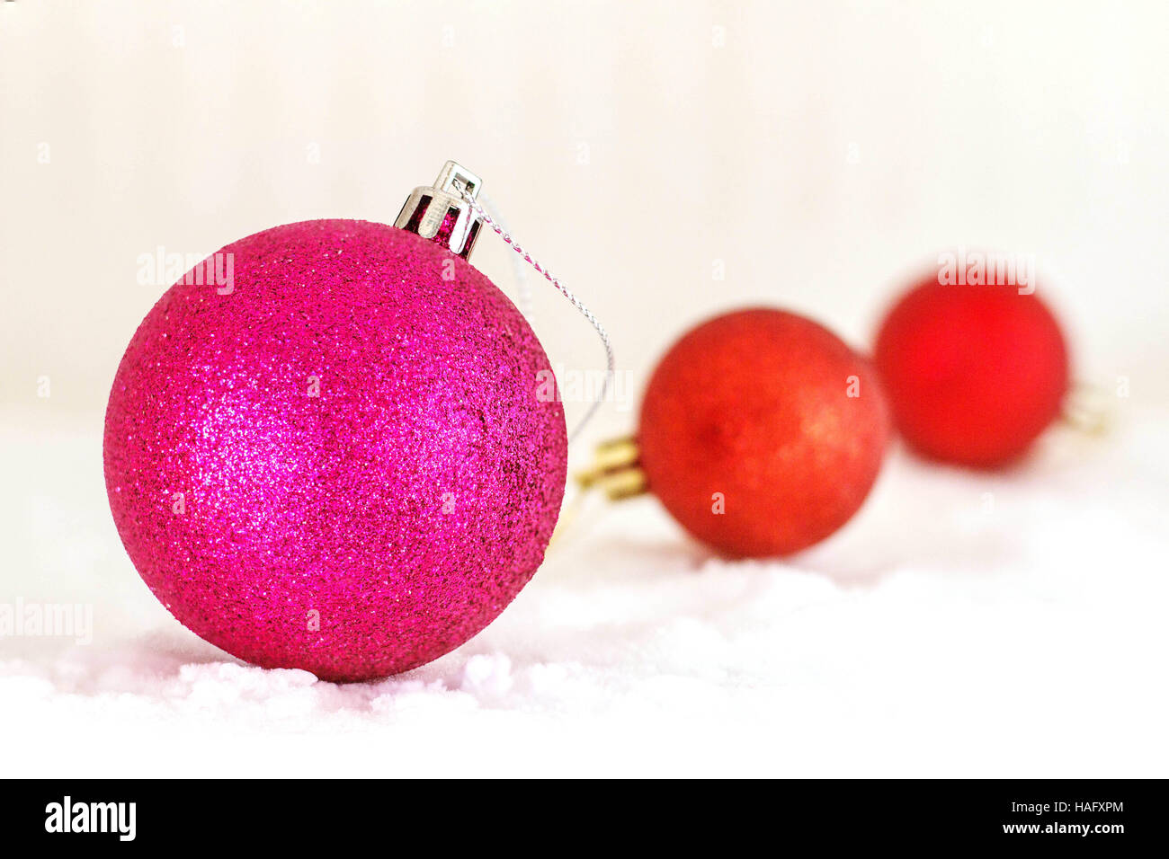 Magenta ball on the ice in winter Stock Photo - Alamy