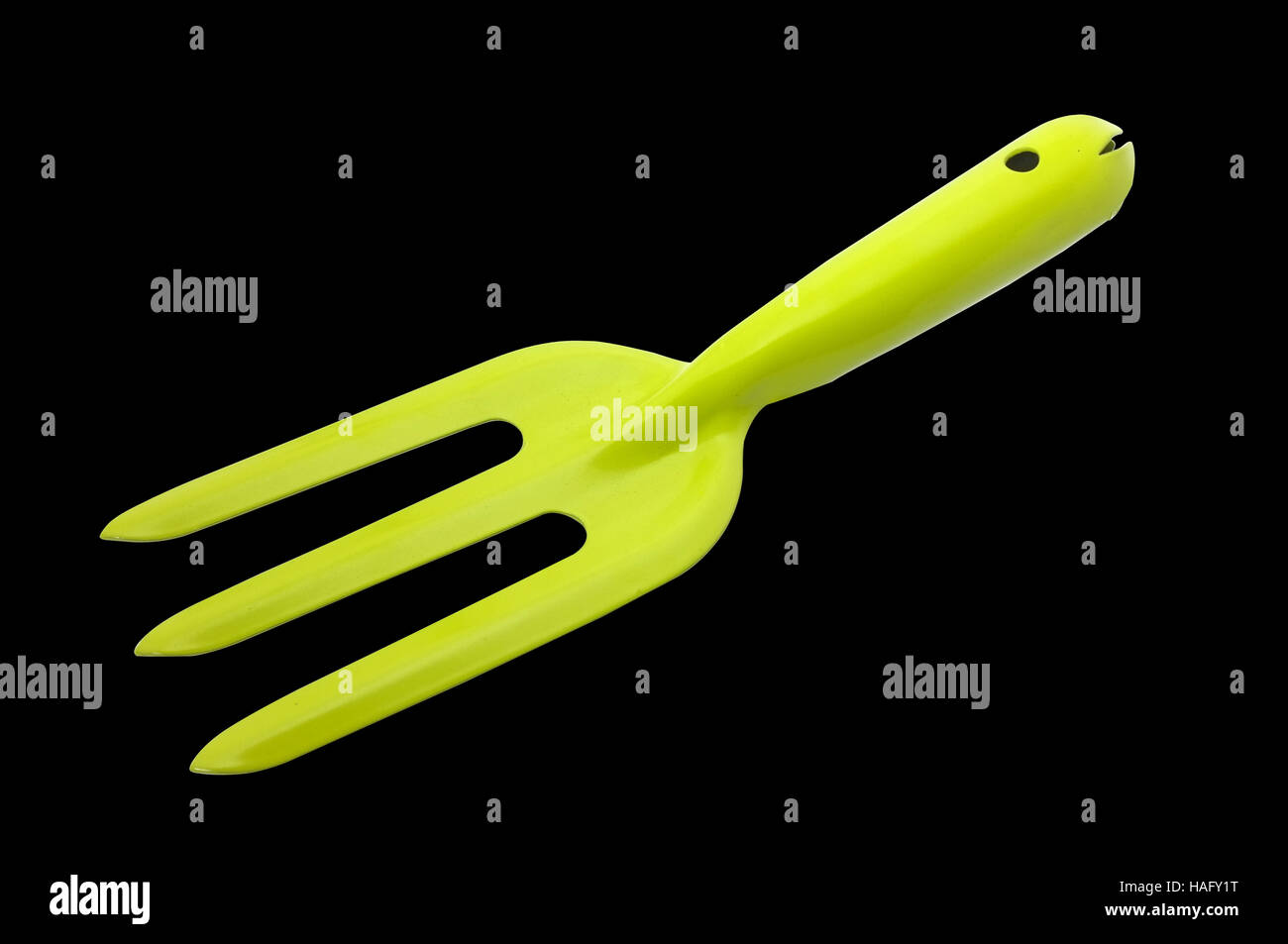 Small gardening , green fork isolated on black background Stock Photo ...