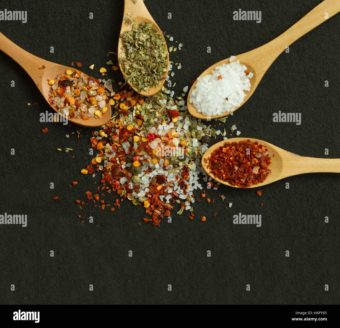 Four spoons with different spices and salt with copy space Stock Photo ...