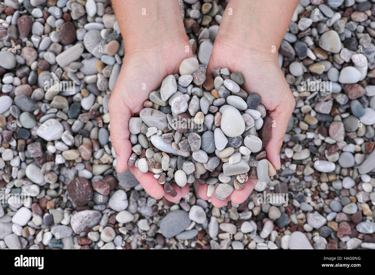 Hands holding pile of stones. Close up Stock Photo - Alamy