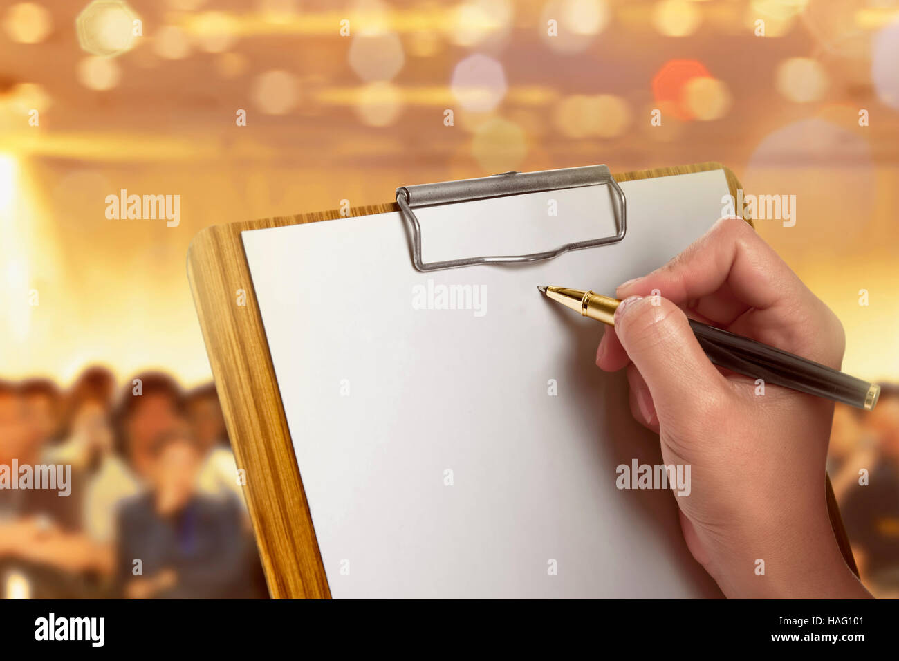Woman write with pen on the paper over blur background. You can use ...