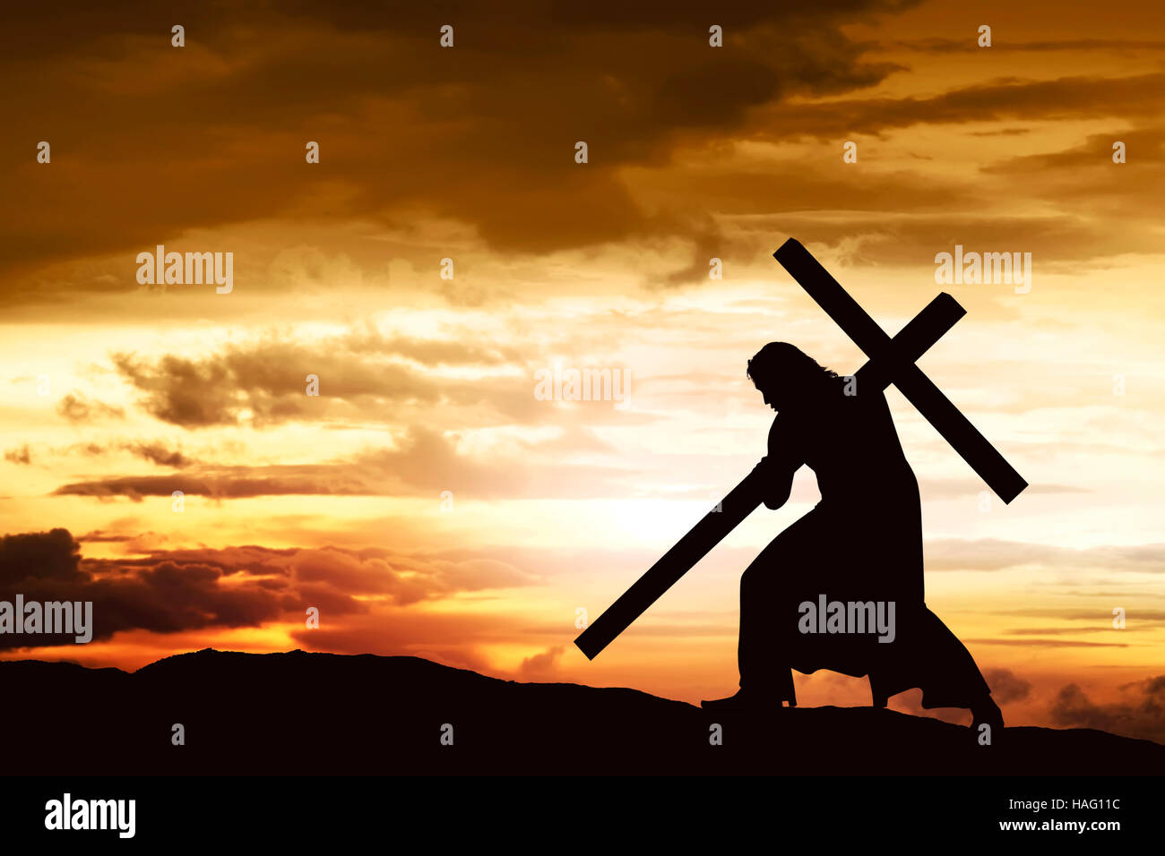 Silhouette of Jesus carry his cross on the hill Stock Photo - Alamy