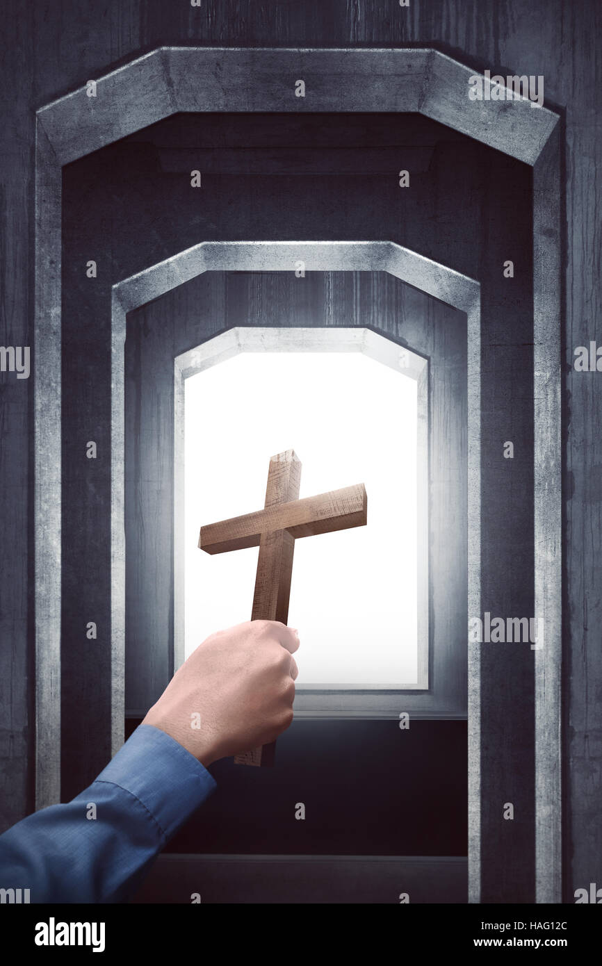 Hand holding christian cross over window background Stock Photo - Alamy