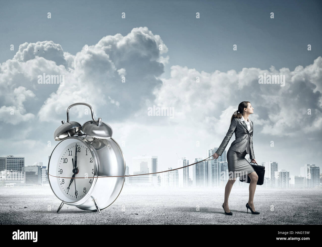 Woman controlling time Stock Photo - Alamy