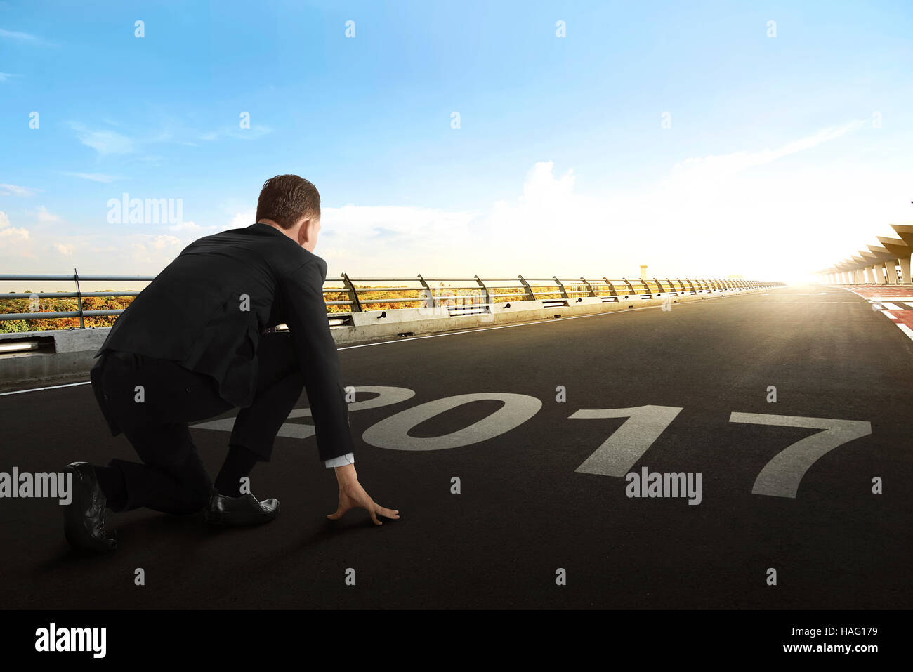 Asian businessman with 2017 numbers as starting line waiting for the ...
