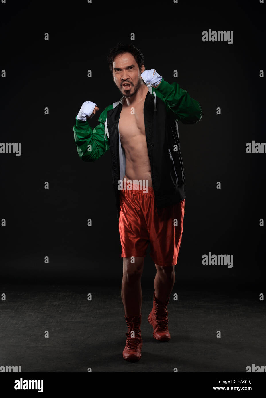 Young asian boxer training boxing against black background Stock Photo ...