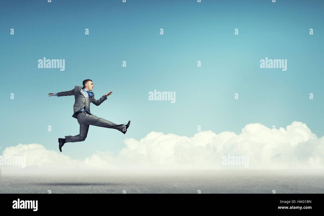 Businessman jumping high Stock Photo - Alamy