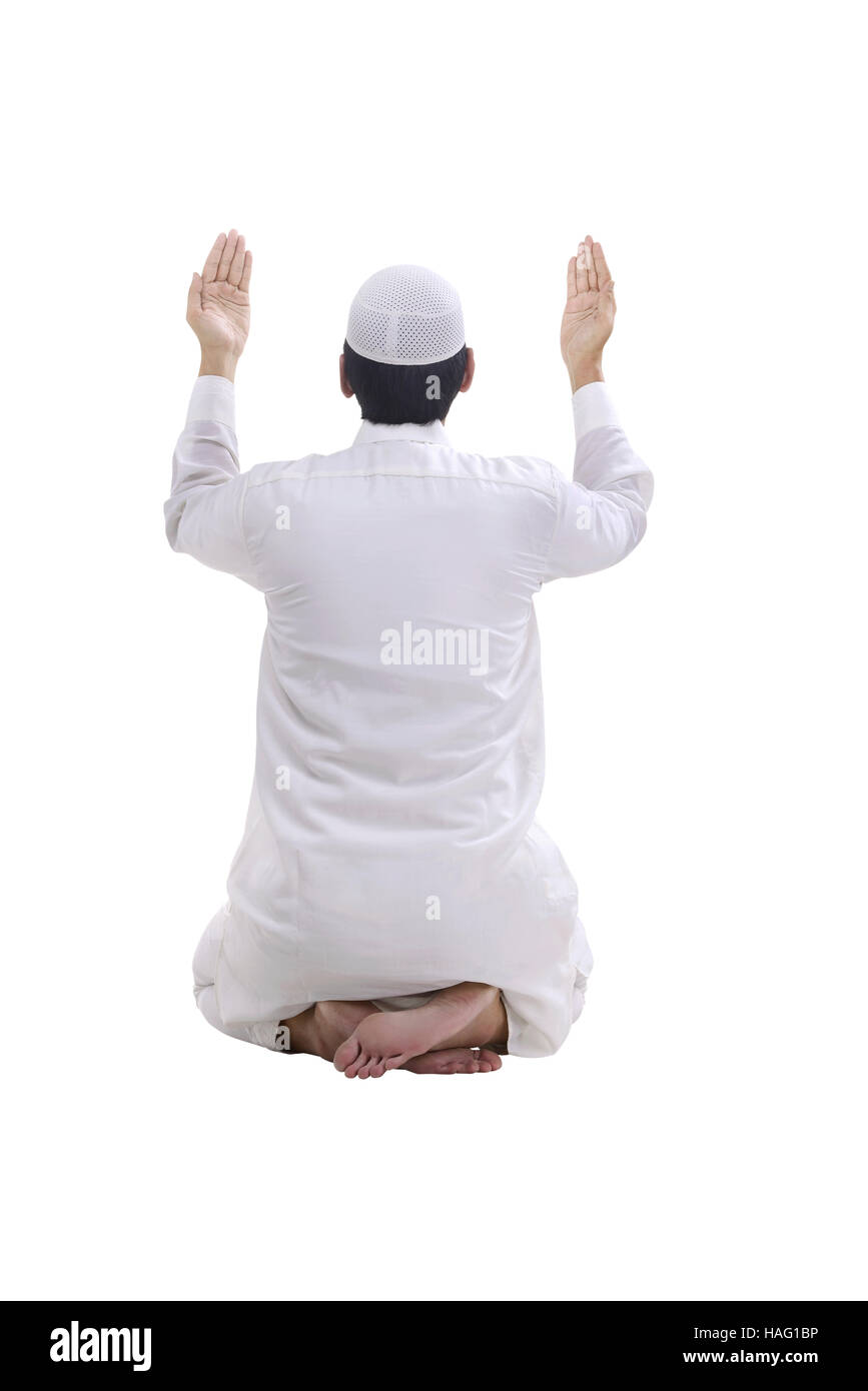 Young muslim man praying isolated over white background Stock Photo - Alamy