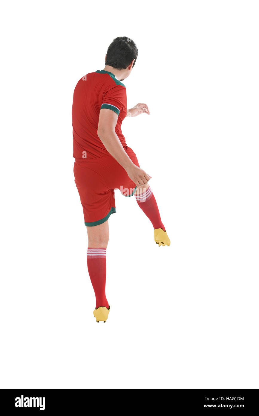 Back view of asian football player kick ball isolated over white ...