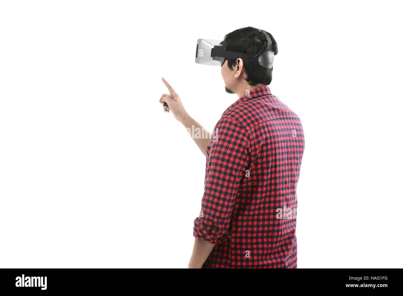 Young asian man experiencing virtual reality through a VR headset isolated on white background ...