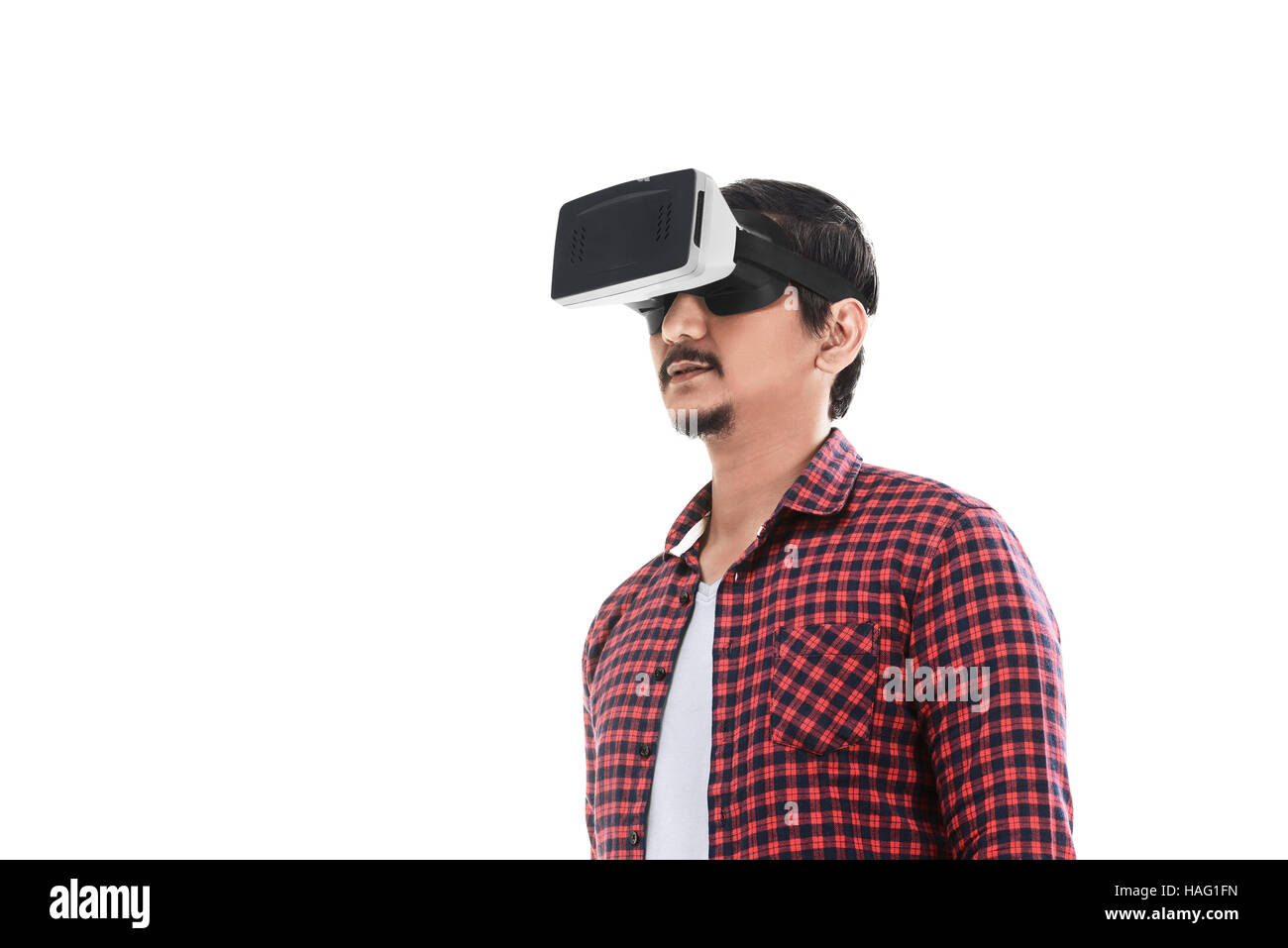 Young asian man experiencing virtual reality through a VR headset ...