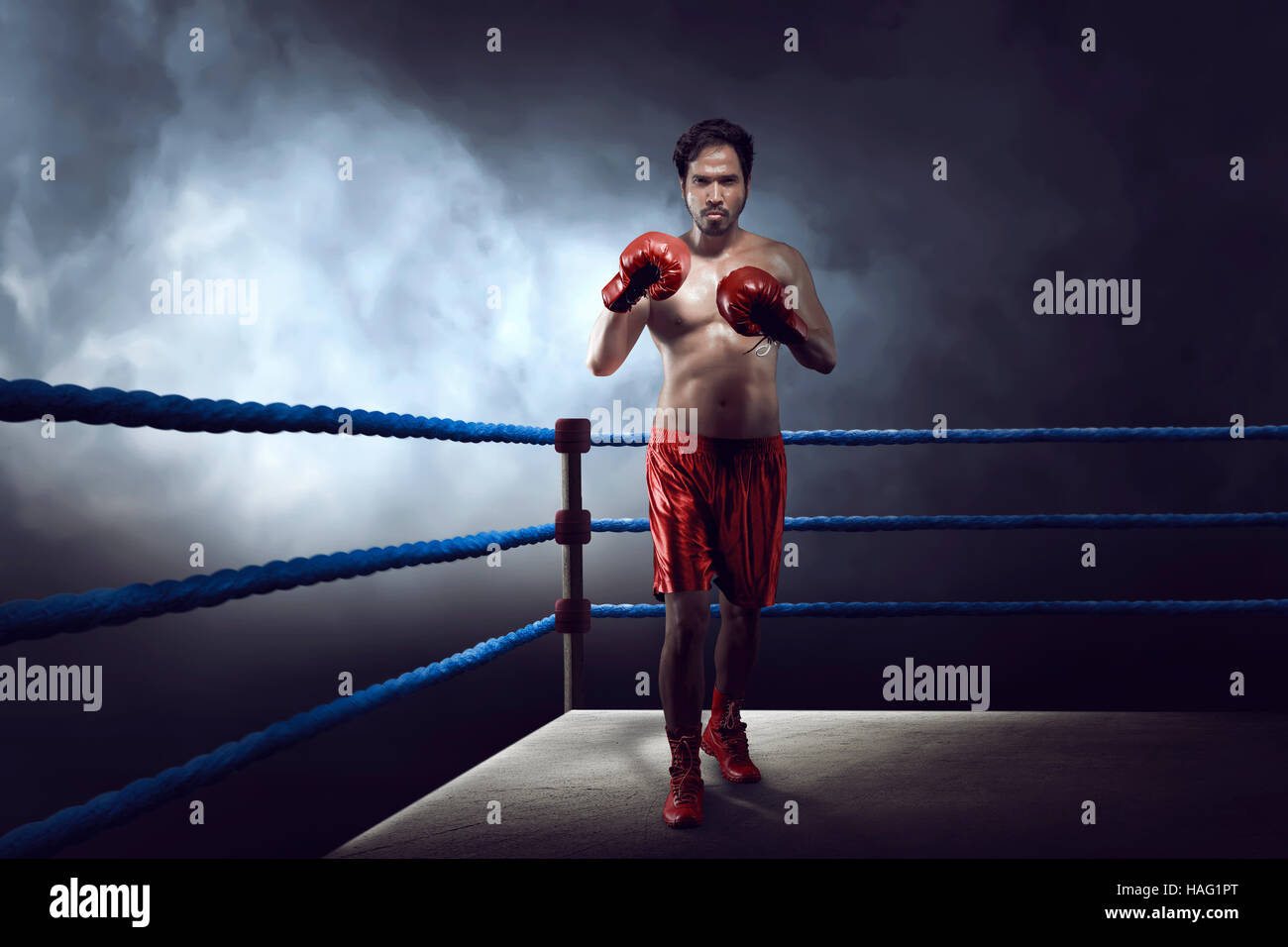 Professional asian boxer guy with glove was practicing on ring boxing ...