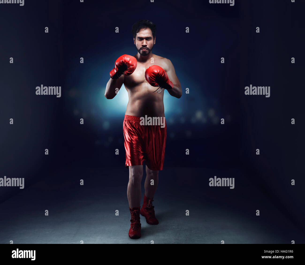 Portrait of asian male boxer with red gloves posing in studio Stock ...