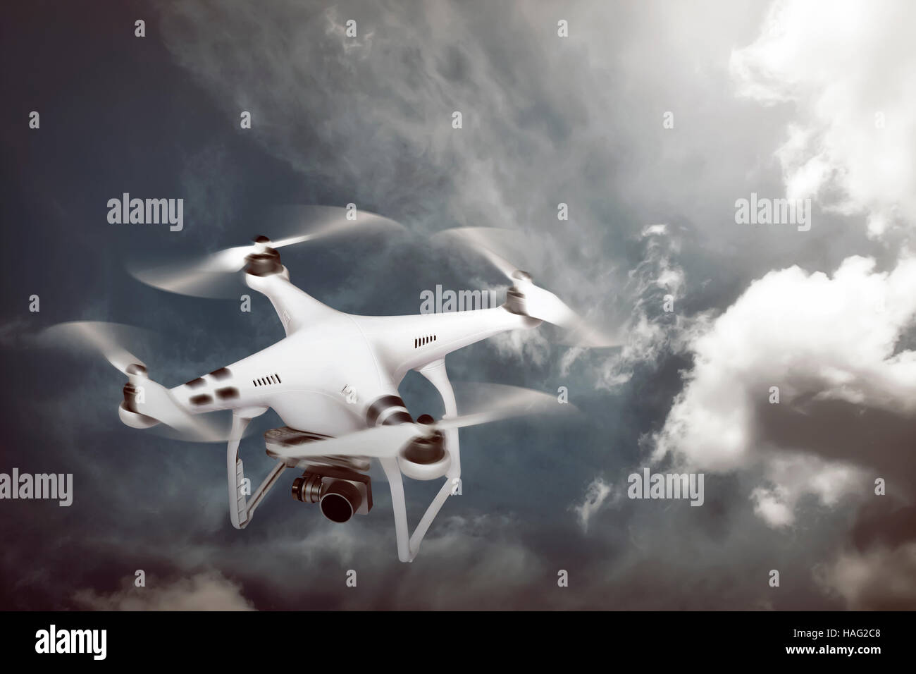 Small white drone hover with blue sky background Stock Photo - Alamy