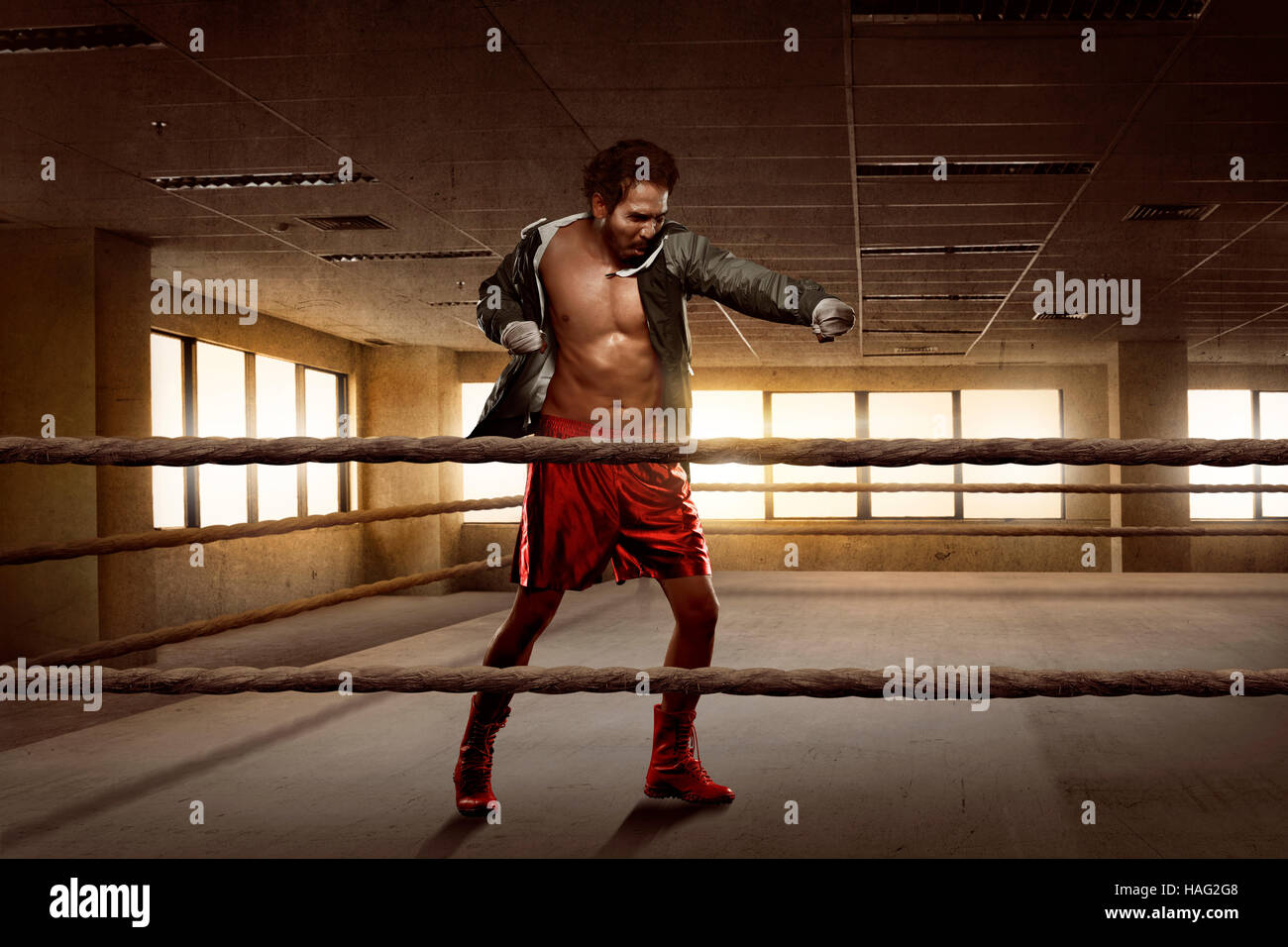 Young asian boxer man workout punching in the boxing ring Stock Photo ...