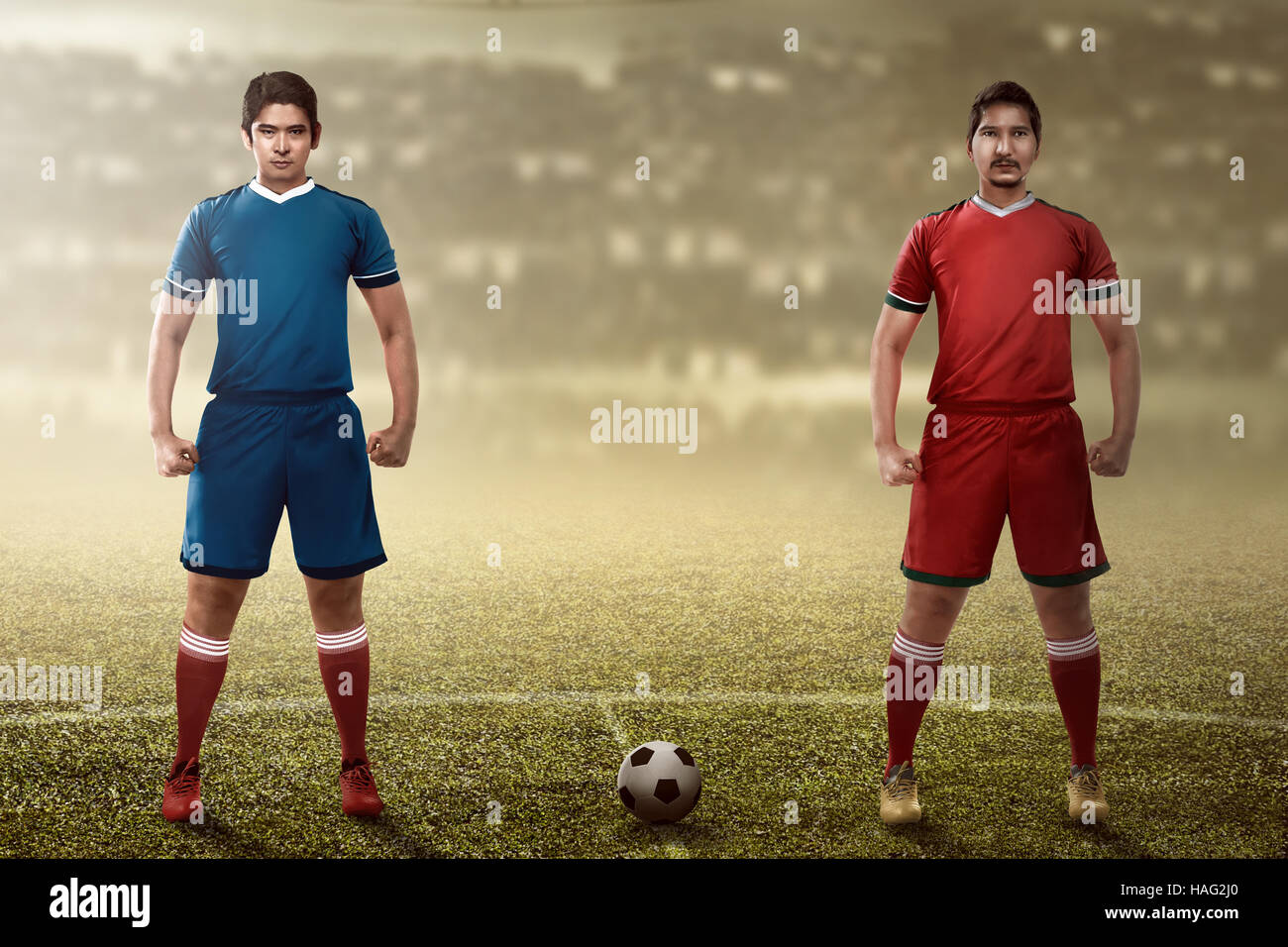 Two football player posing on the kickoff at the stadium Stock Photo ...