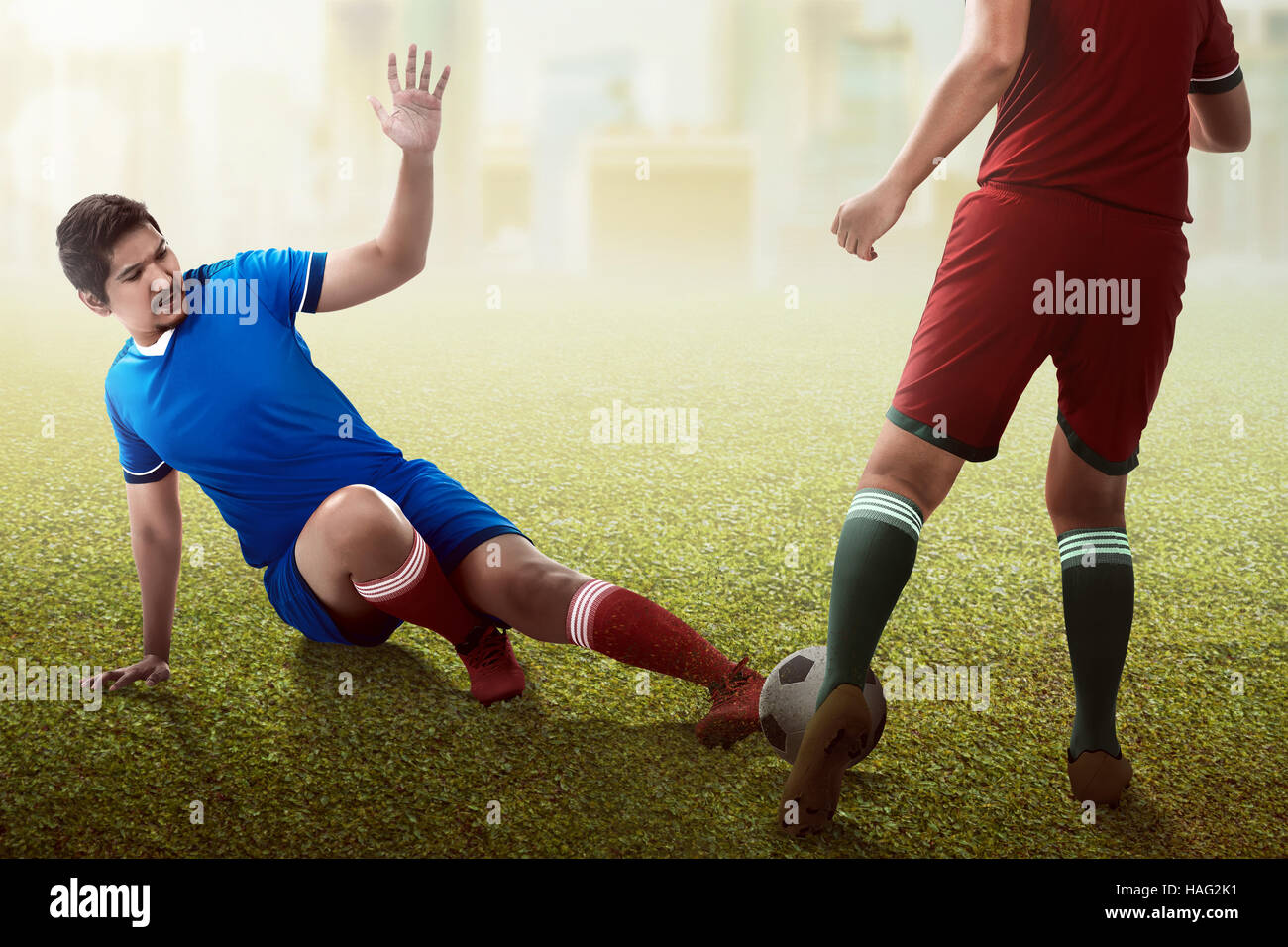 Football player tackling for the ball against other team Stock Photo ...