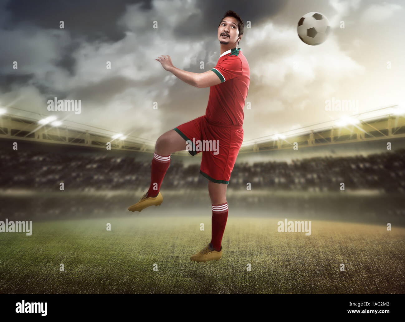 Professional football player header ball with his head Stock Photo - Alamy