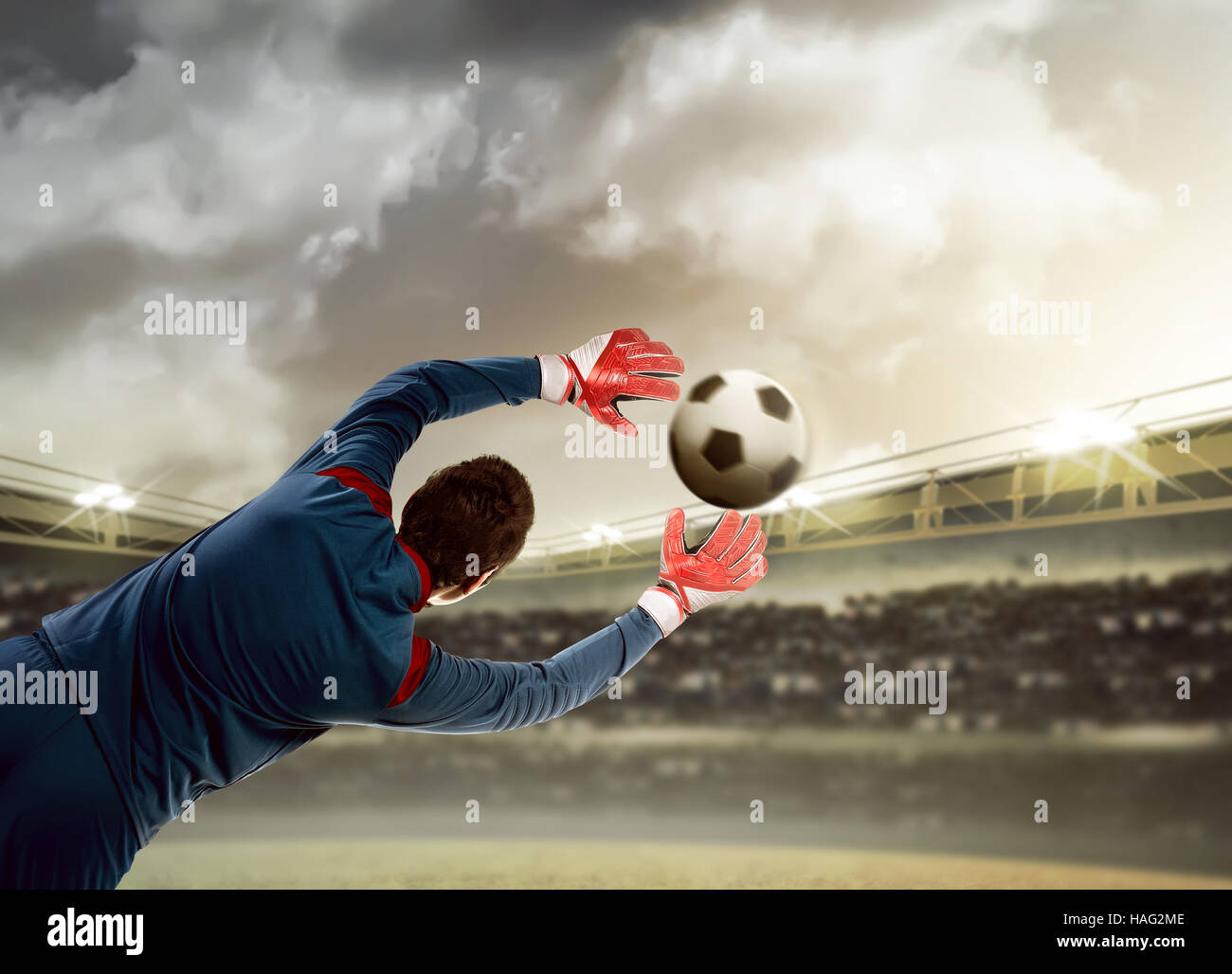 Image of goalkeeper catching ball on the field Stock Photo - Alamy
