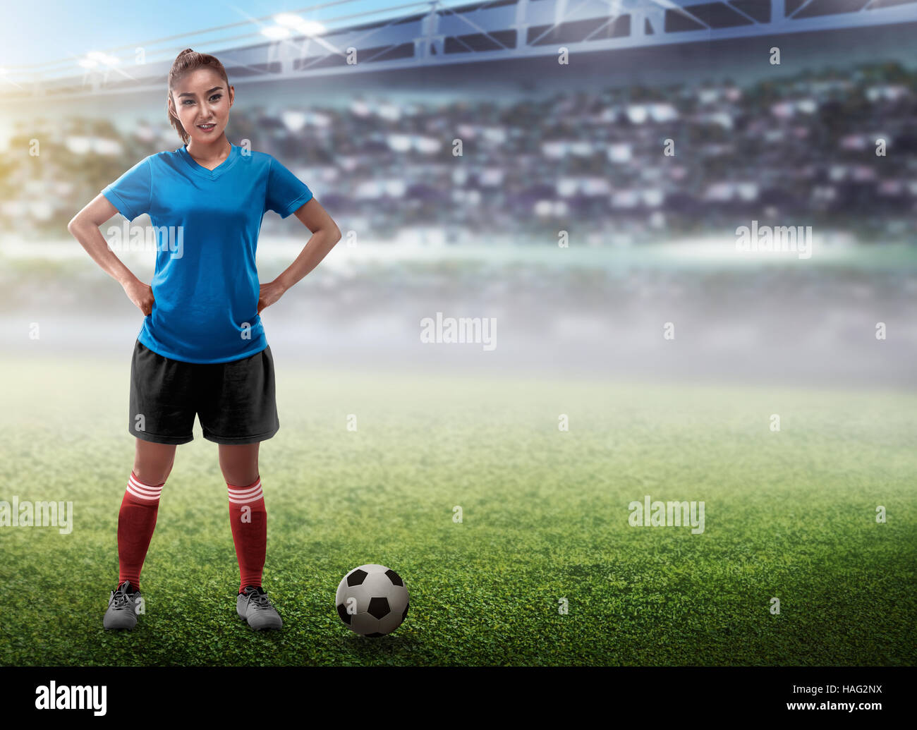 Female football player standing on the field Stock Photo - Alamy