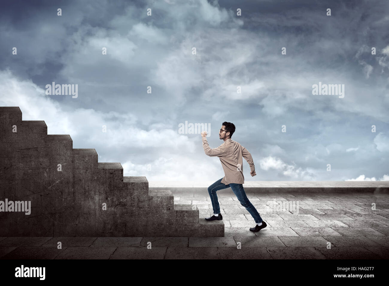 Young asian business man getting steps up to the stairs Stock Photo - Alamy