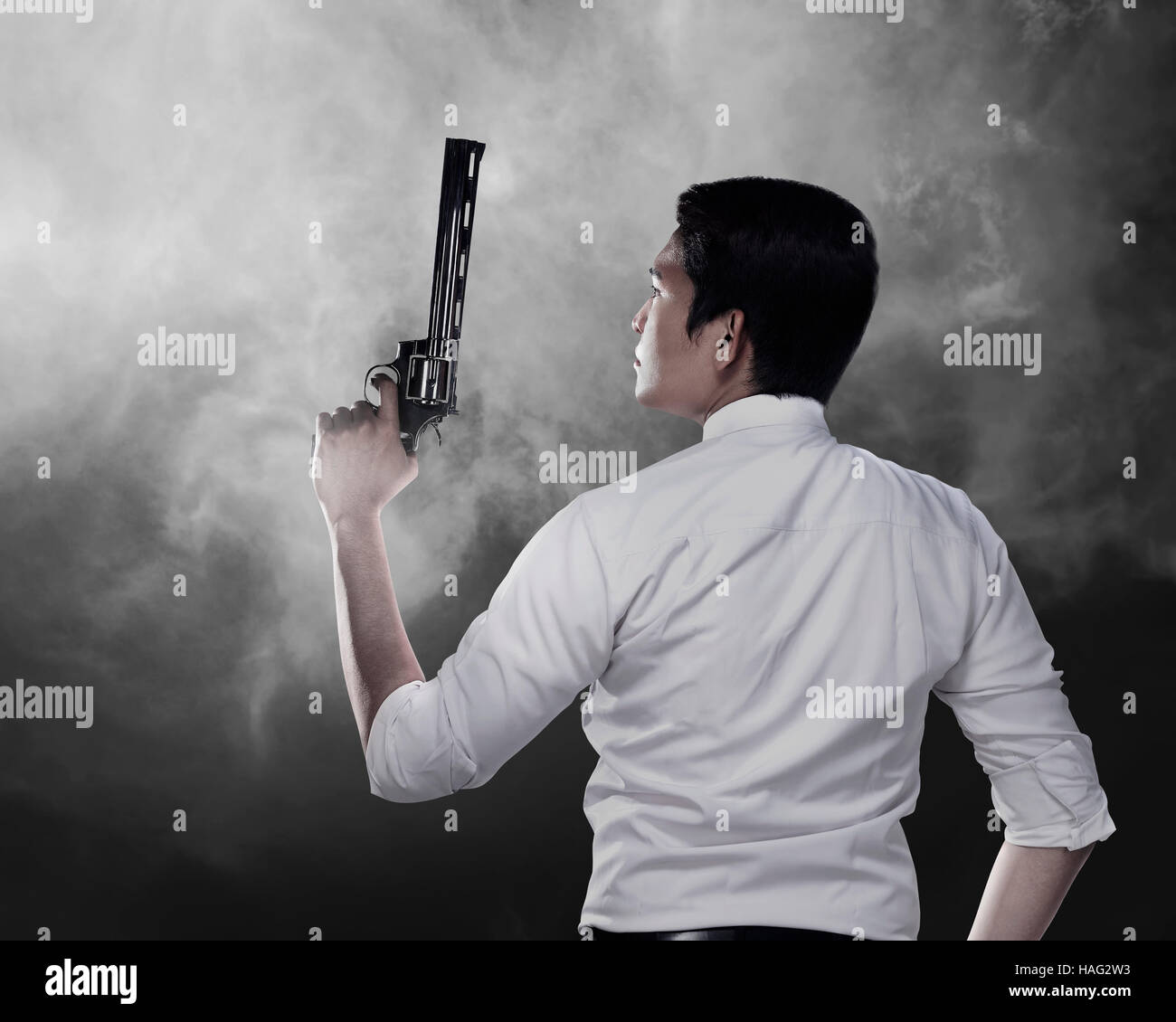 Secret agent holding gun ready to fire Stock Photo - Alamy