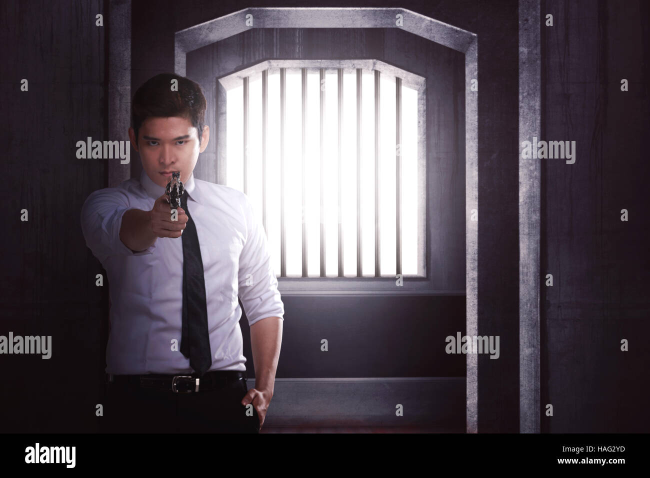 Secret agent holding gun ready to fire Stock Photo - Alamy