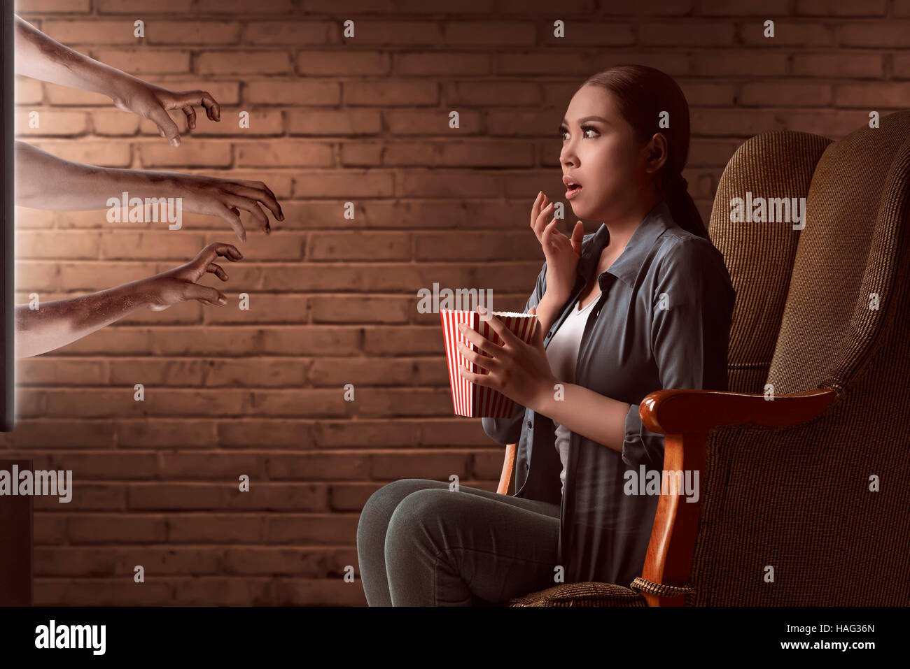 Young Asian Woman Watching Horror Movie And Eat The Popcorn With