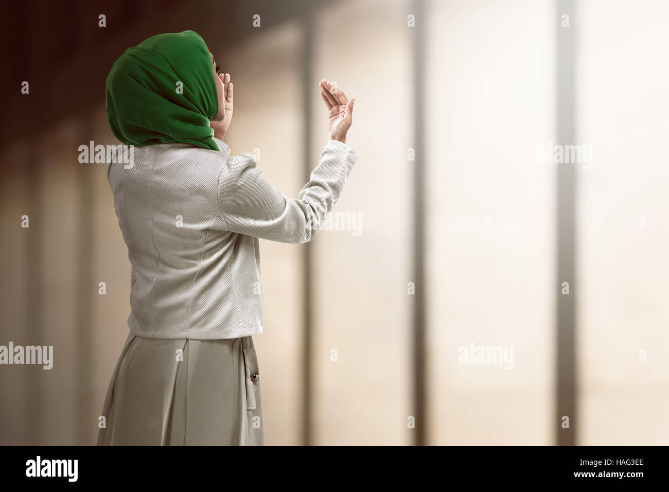 Back view of muslim woman praying wearing hijab Stock Photo - Alamy