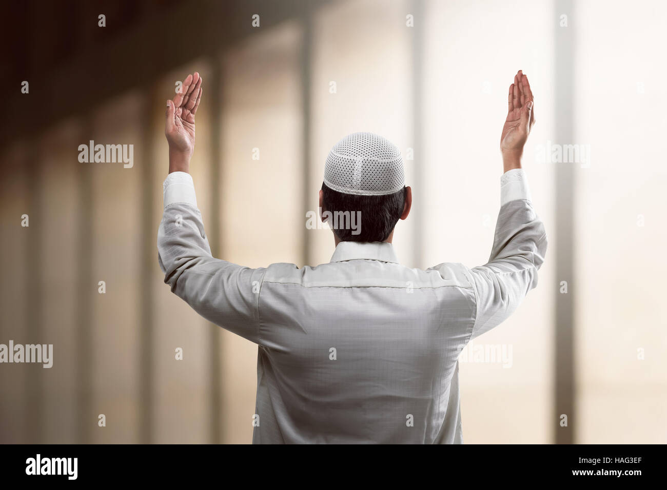 Back view of young muslim man praying Stock Photo - Alamy