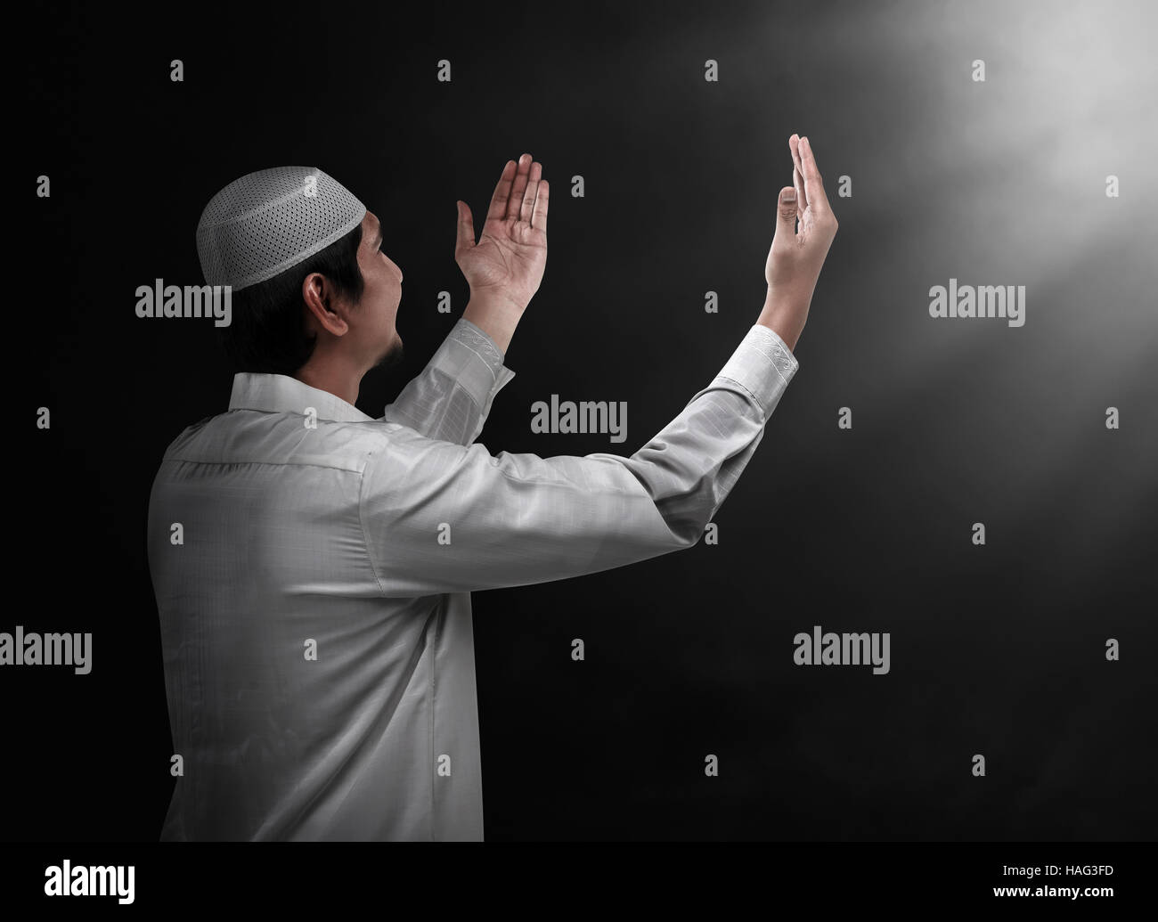 Back view of young muslim man praying Stock Photo - Alamy