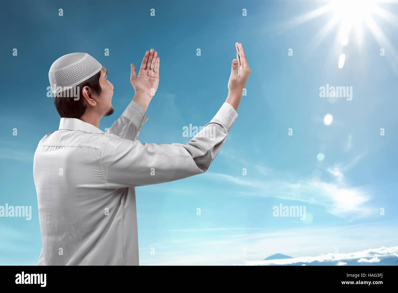 Back view of young muslim man praying Stock Photo - Alamy