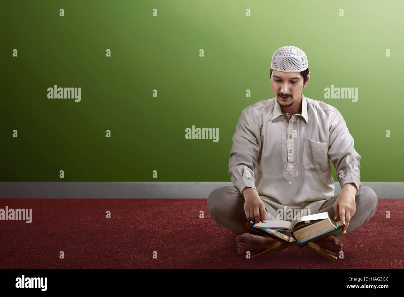 Young asian muslim people reading koran on the mosque Stock Photo - Alamy