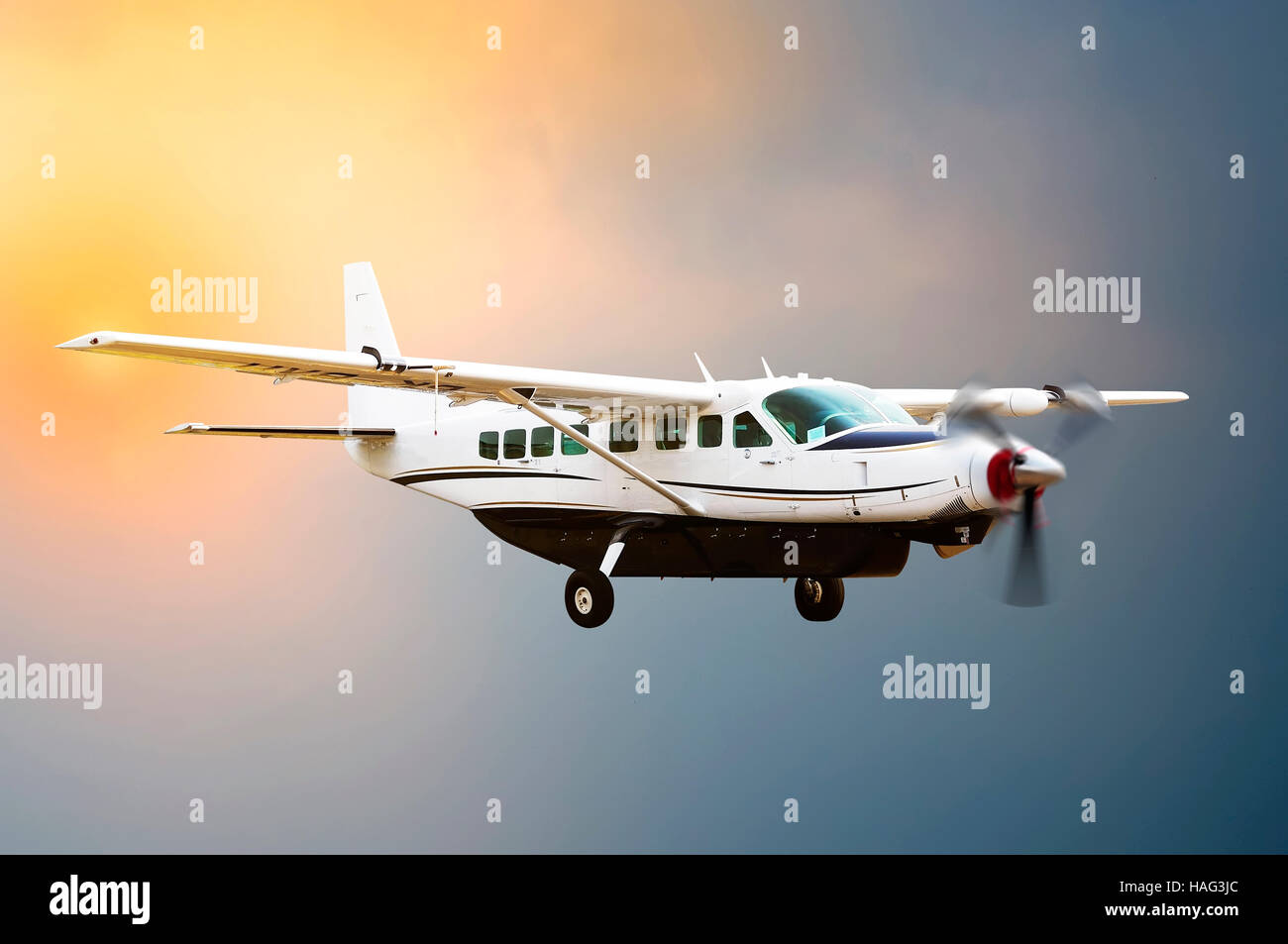 Propeller plane flying on the sunset sky Stock Photo - Alamy