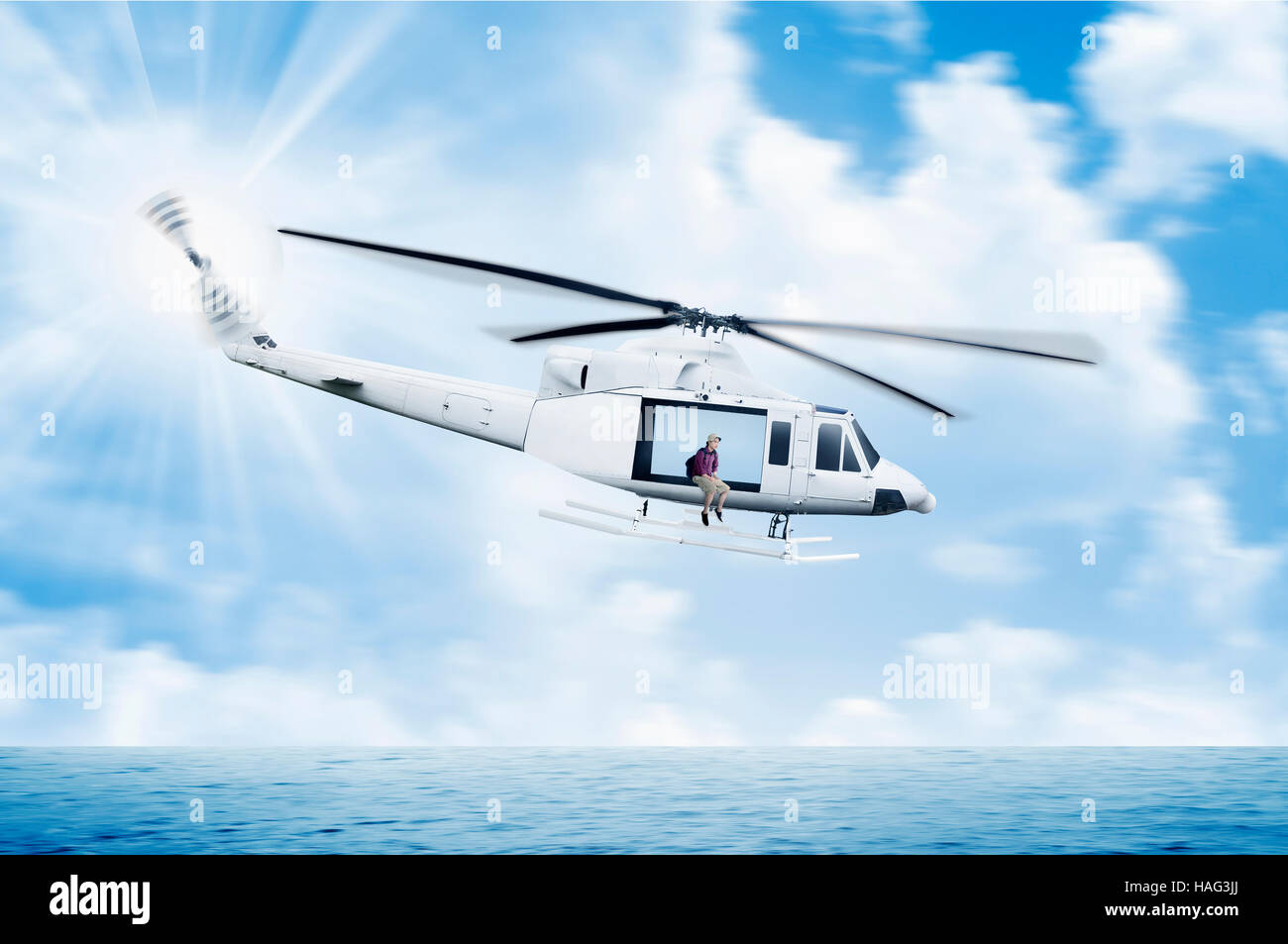 Asian man sitting inside helicopter while flying Stock Photo - Alamy