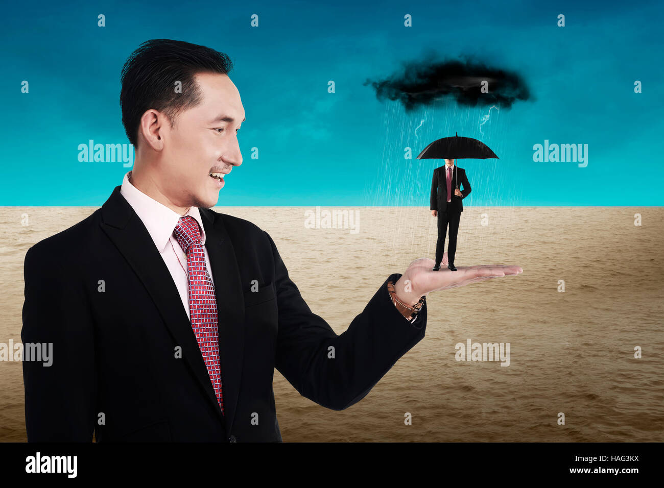 Business man holding small man using umbrella to protect himself from ...