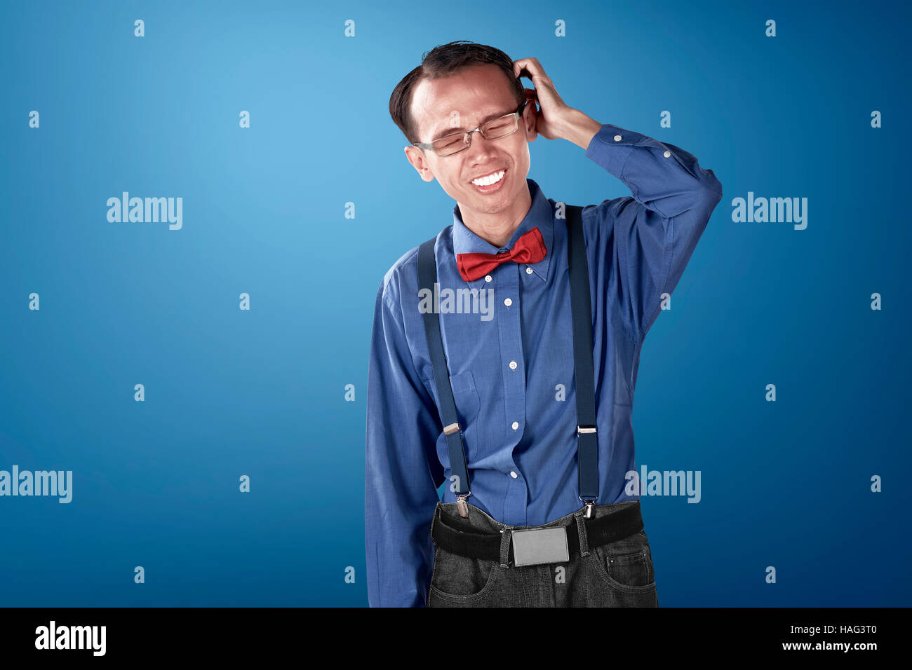 Nerdy business man confused with blue background, dressed blue and bow ...