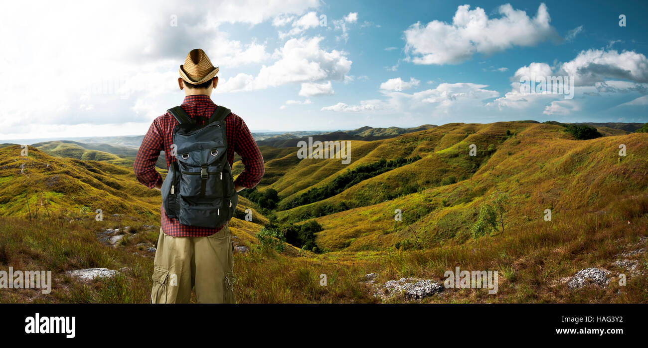 Back view of young traveler standing looking the mountain Stock Photo ...