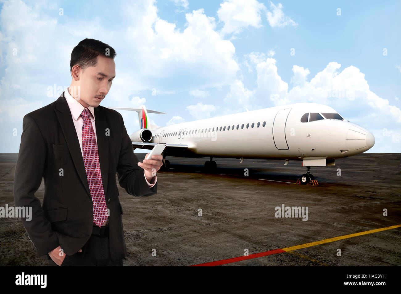 Asian business man calling with his cellphone with plane background ...