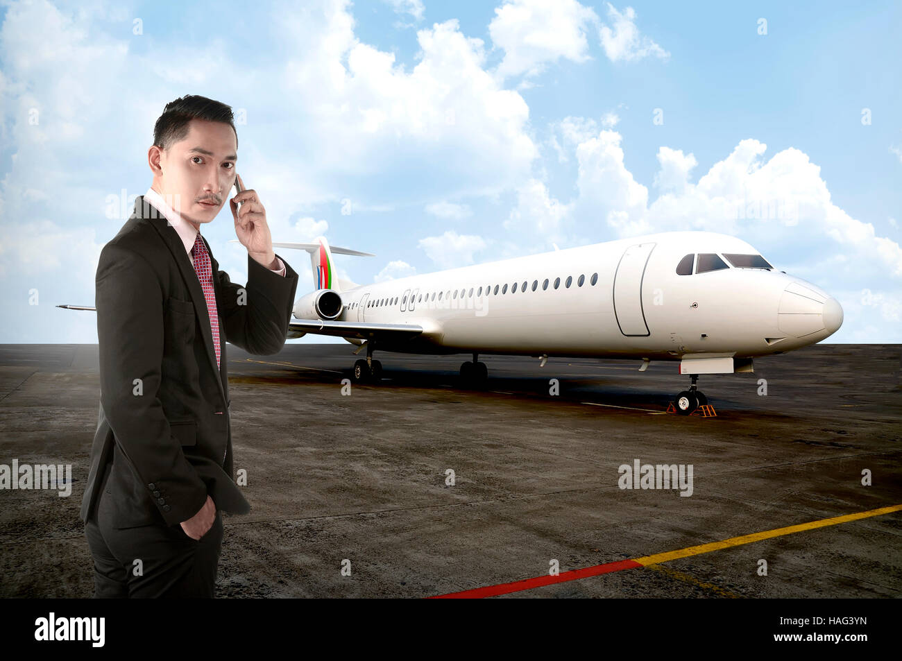 Asian business man calling with his cellphone with plane background ...