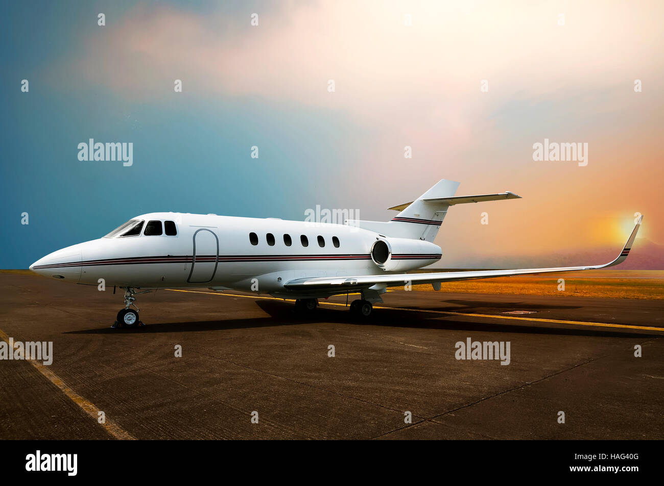 Private jet airplane parking at the airport. With sunset background ...