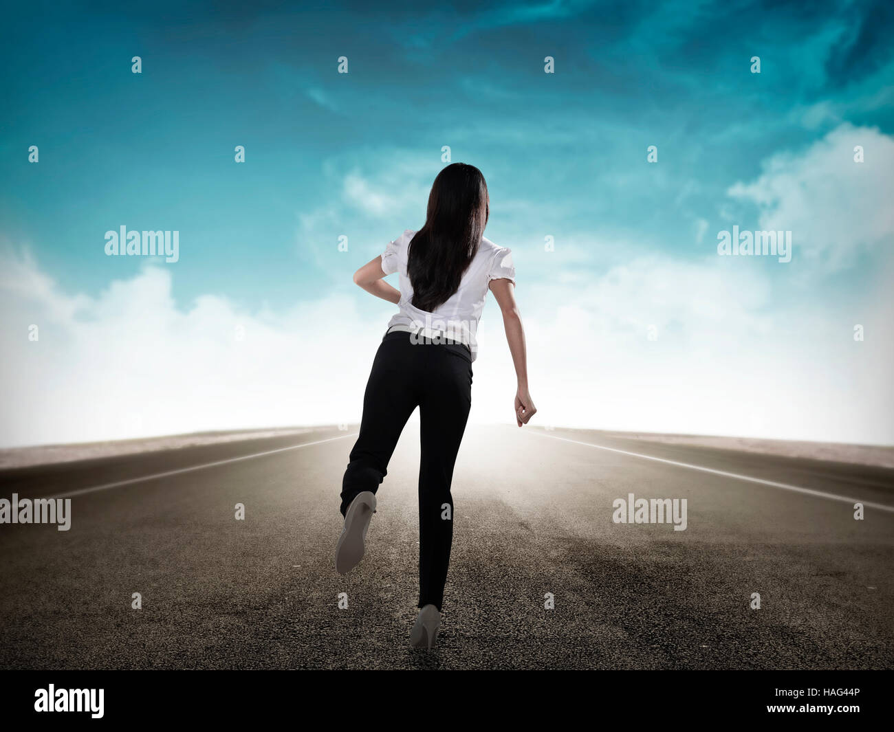 Back view of business man running to the city Stock Photo - Alamy