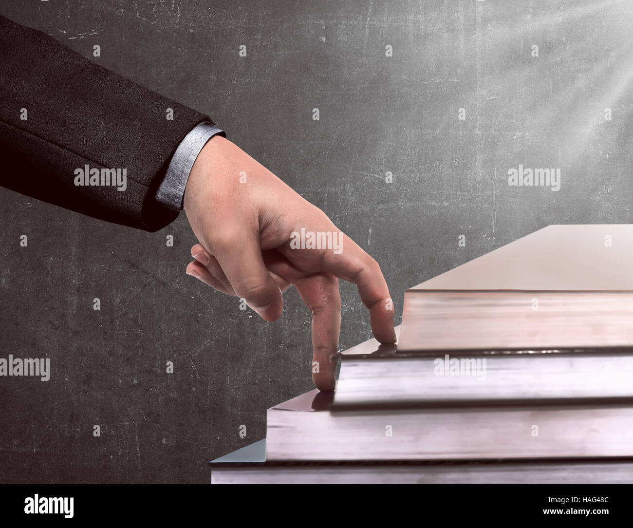 Hand and book stairs. Education for career concept Stock Photo - Alamy