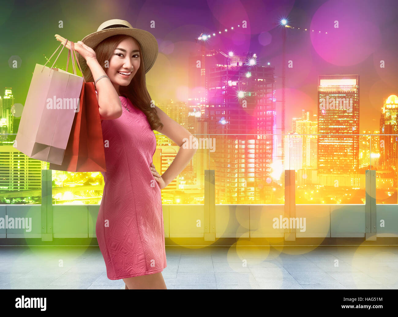 Happy shopping asian woman with shopping bags in motion Stock Photo - Alamy