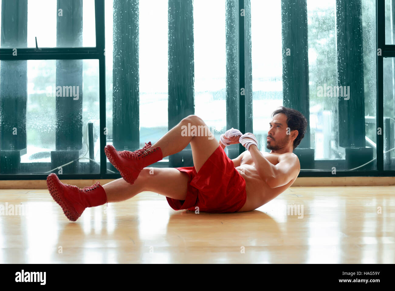 Fitness asian man doing exercise sit up lying in the floor Stock Photo ...
